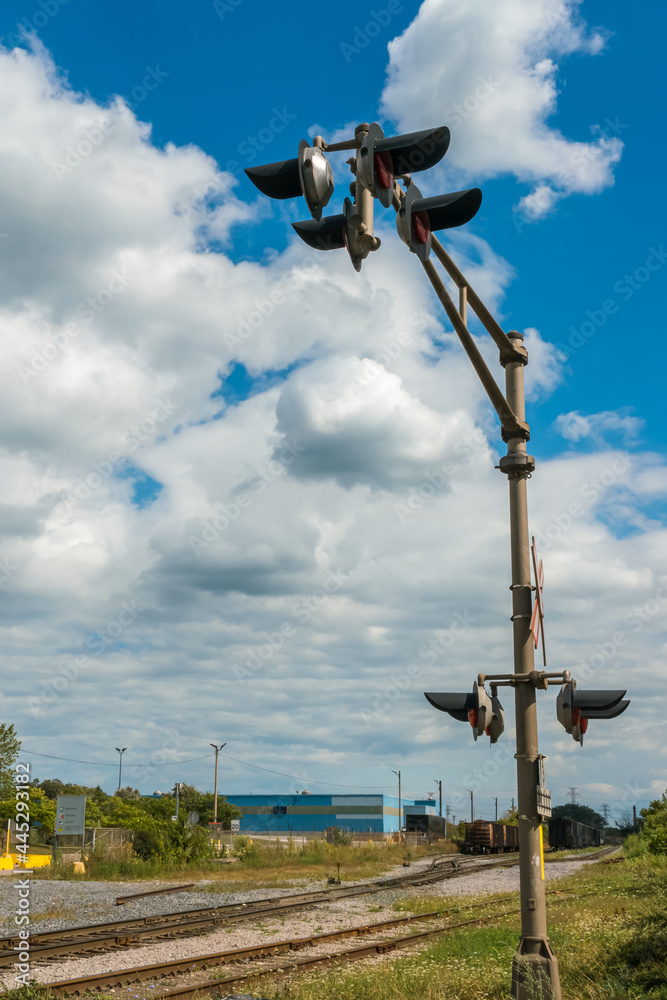 Railroad crossing sign and lights at a level crossing with trains in ...
