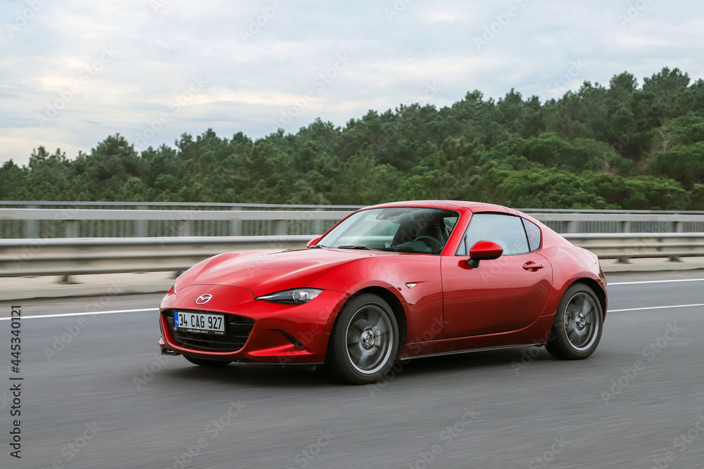 Mazda MX-5, is a lightweight two-seater roadster with a front-engine ...