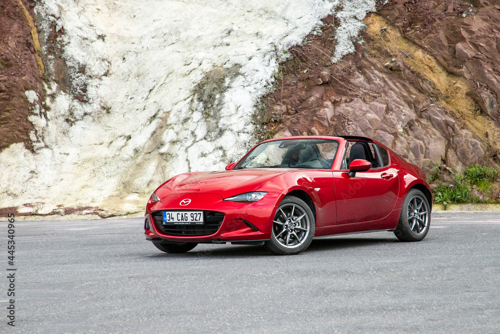 Mazda MX-5, is a lightweight two-seater roadster with a front-engine ...