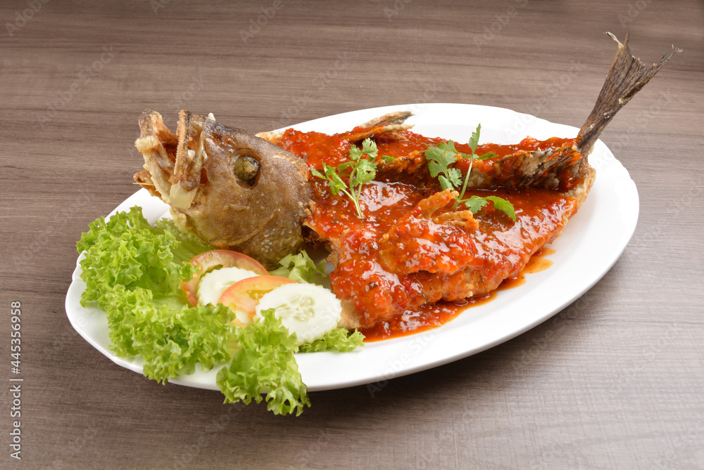 deep fried crispy whole grouper fish with spicy sambal chilli sauce on ...