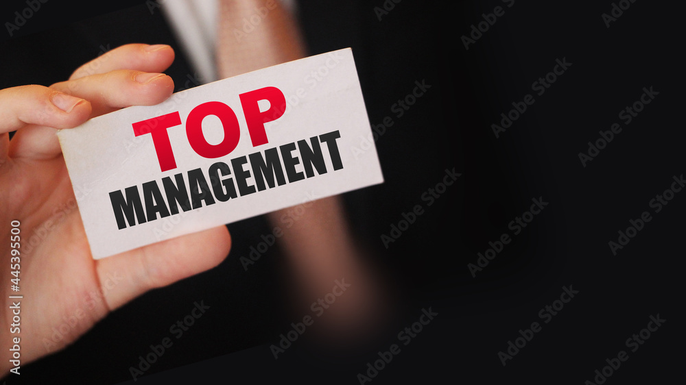 Businessman shows a card with word Top Management. CEO position ...