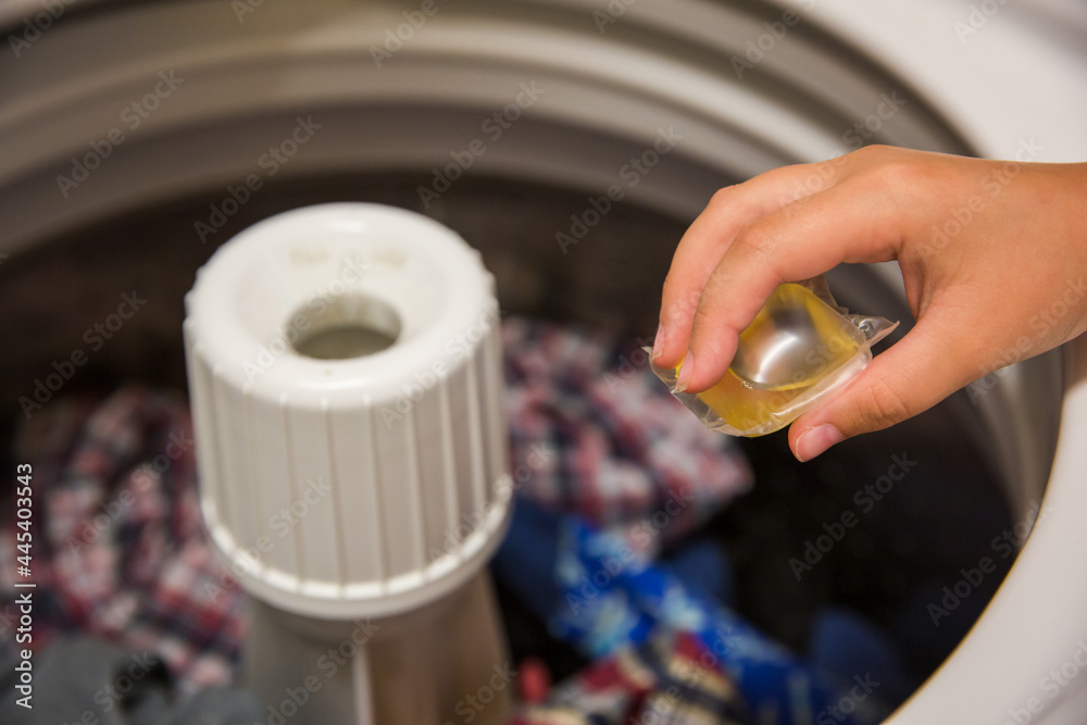 Child's Hand Placing Laundry Pod in Top Loading Washing Machine Stock ...