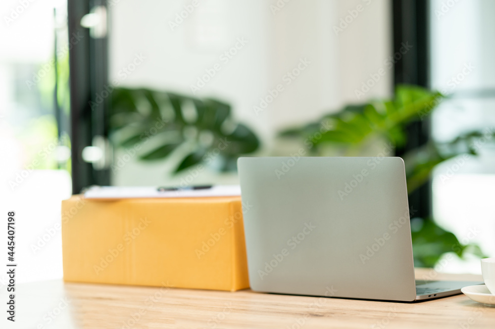 Laptop computer at workplace of start up small business owner.cardboard ...