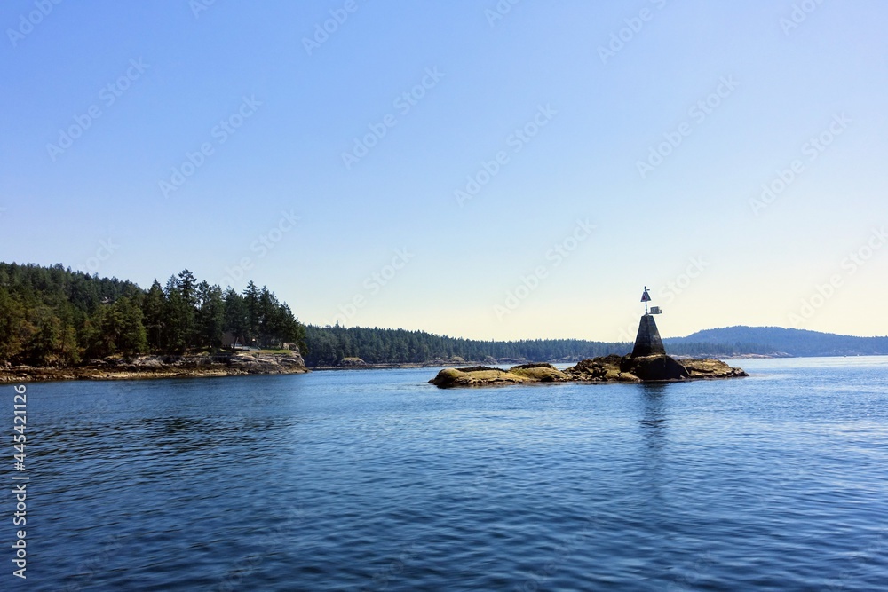 A low tide view of a starboard hand day beacon on a reef, which has a ...