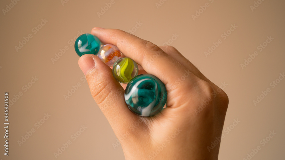Canicas en mano Stock Photo | Adobe Stock