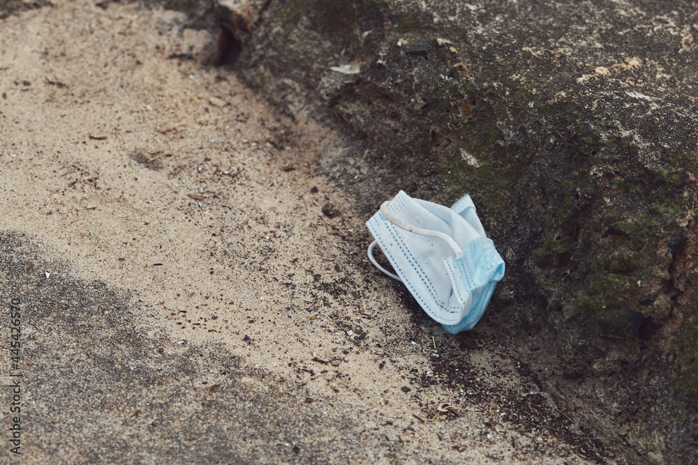 Thrown out medical mask. Used medical devices in nature. Rubbish and ...