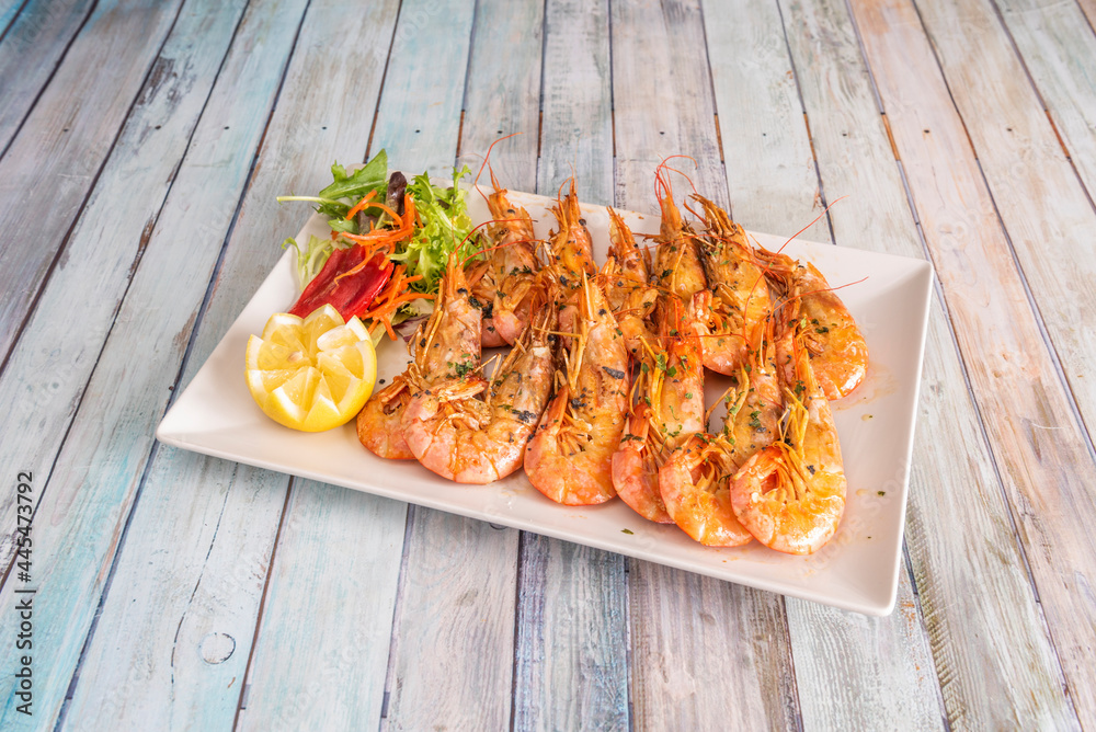 Tray of great grilled fried prawns with spurts of lemon, garlic and ...