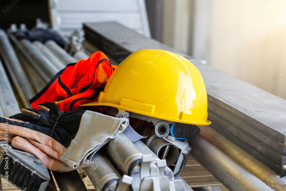 yellow helmet safety in construction site. helmet and reflective vest ...
