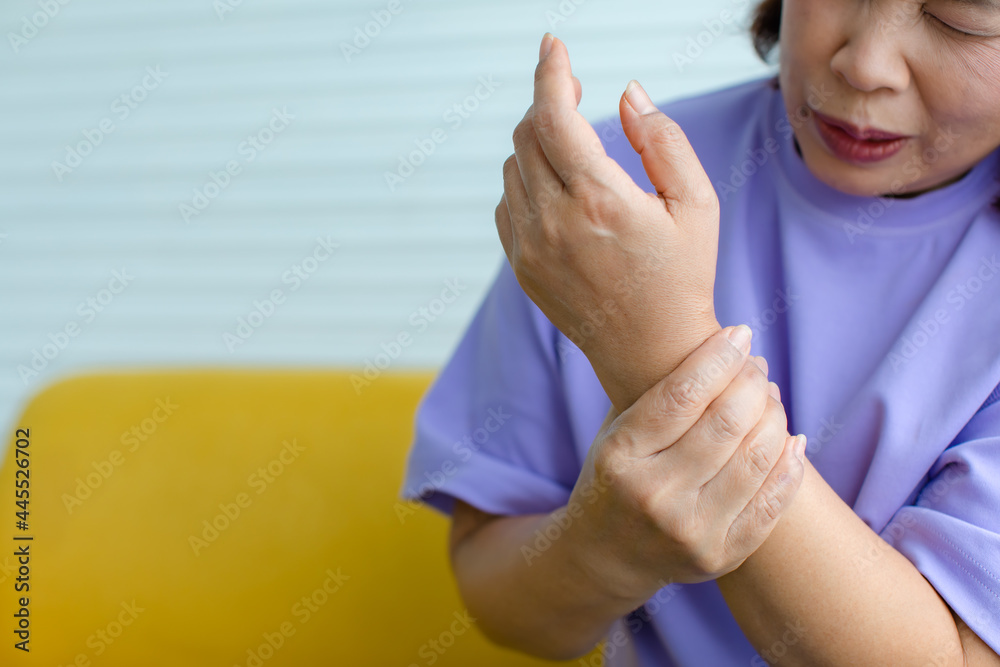 Woman using hand to hold other on arm with and feeling pain, suffer ...