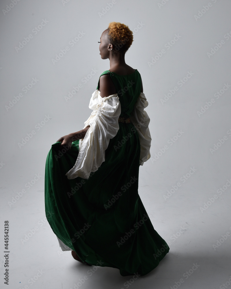 Full length portrait of pretty African woman wearing long green ...
