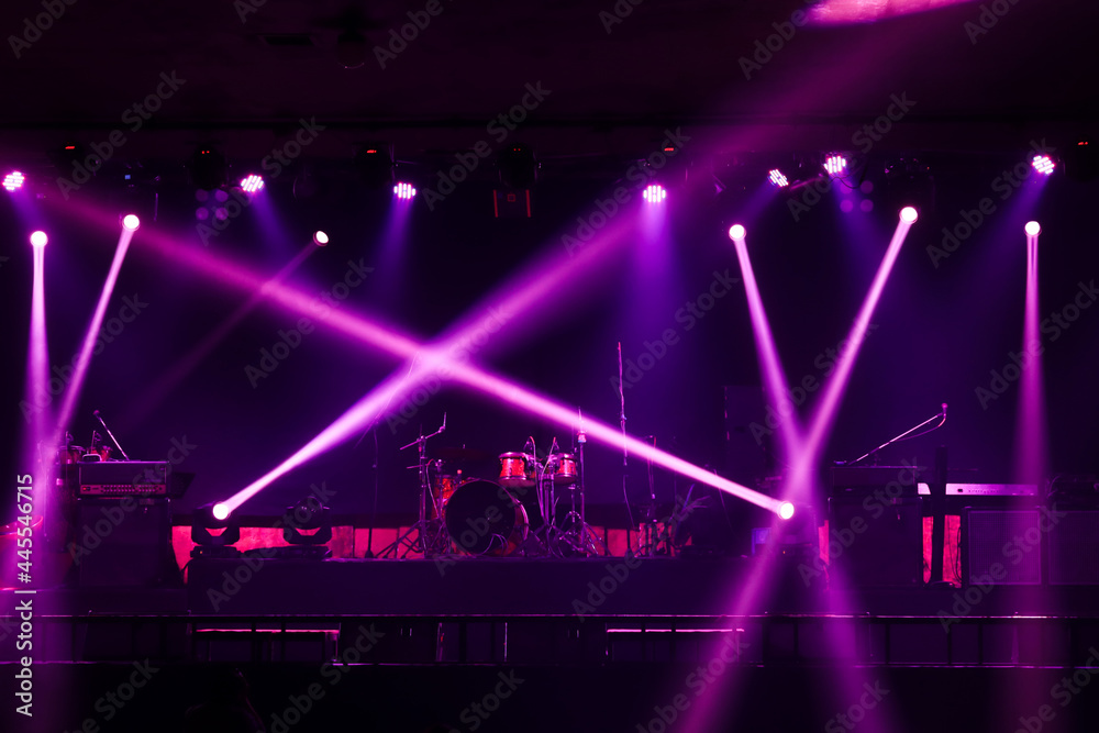 Colorful glow bright spotlights with smoke on stage in dark background ...