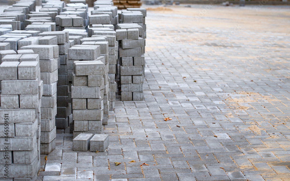 Gray paving slab stacked in rows and ready to pave. Repair pavement and ...