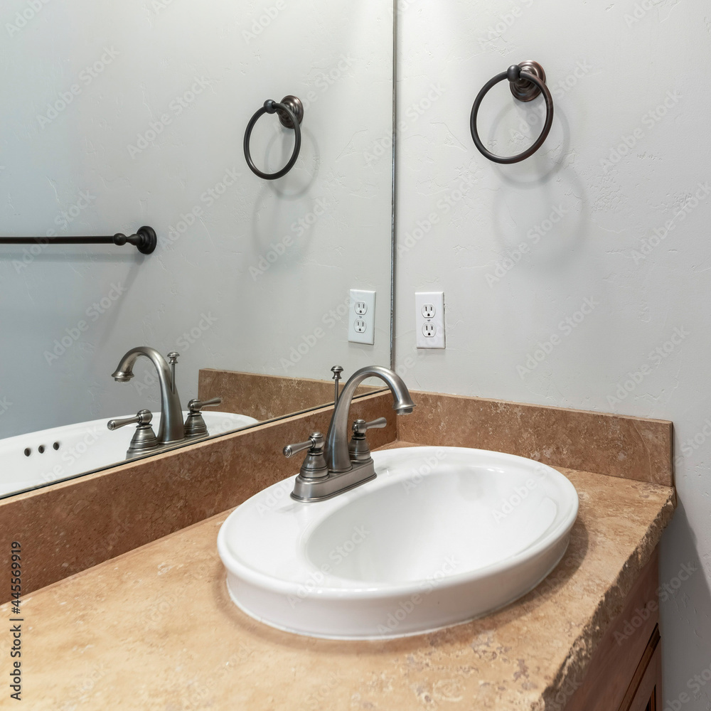 Square frame Sink with granite countertop and a mirror inside the ...