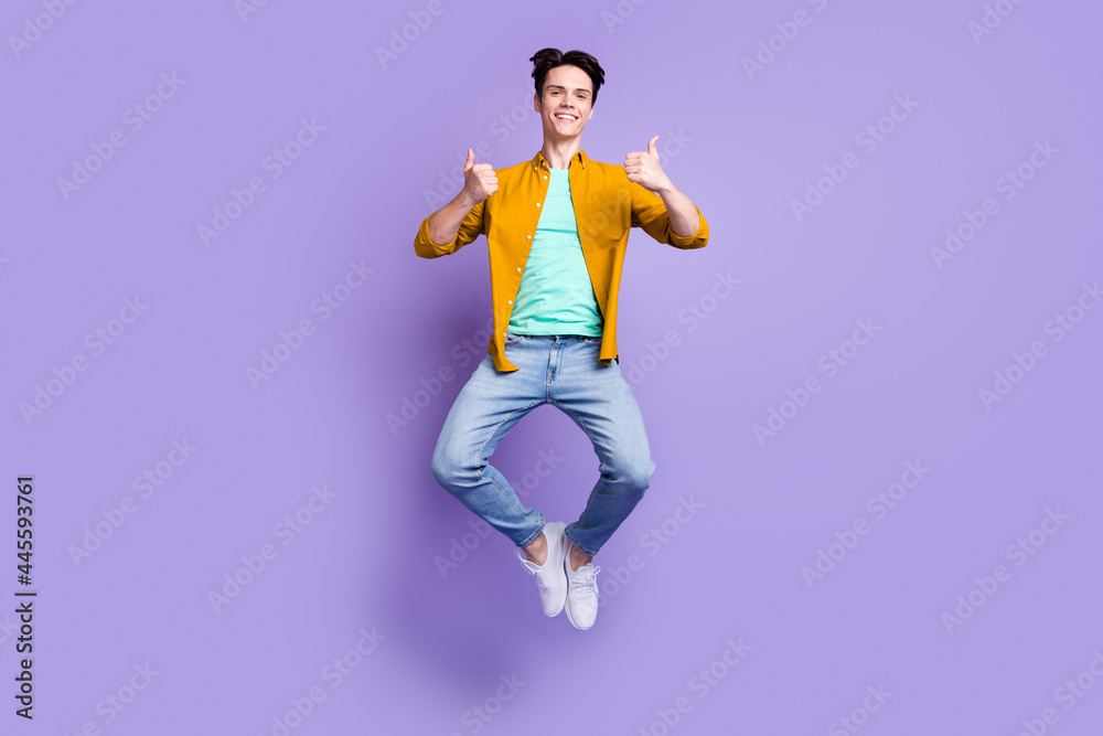 Full length photo of young man happy positive smile jump up show thumb ...