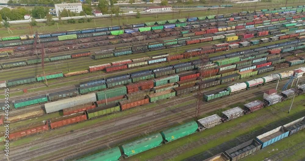 Fly over a large number of freight trains. There are many trains at a ...