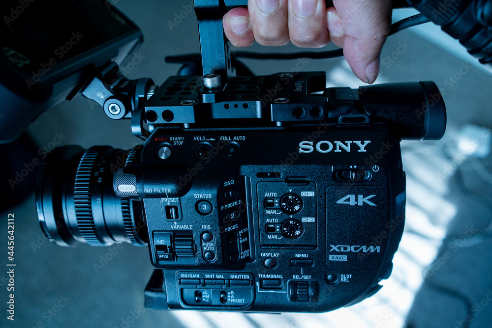 Man's hand reverse grip holding a Sony FS5 4K cinema camera body by the ...