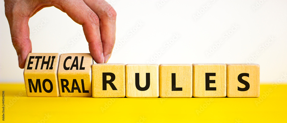 Ethical or moral rules symbol. Businessman turns wooden cubes and ...