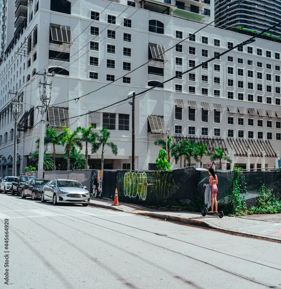 people walking in the city street woman bike cars palms brickell ...