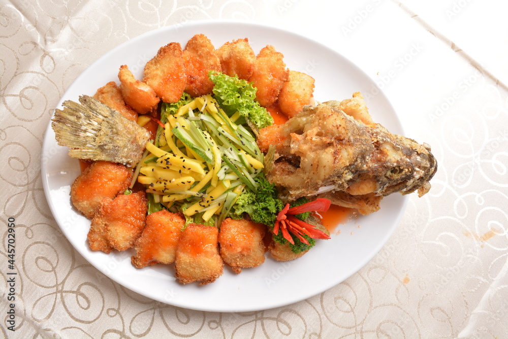 deep fried whole grouper fish seafood with sweet and sour sauce & mango ...
