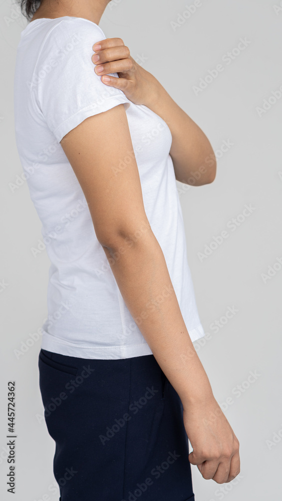 Woman with shoulder pain and yoke holding hands and white background ...