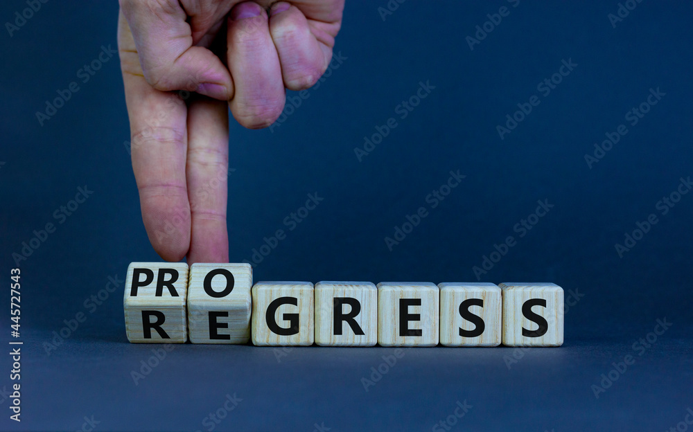 Regress or progress symbol. Businessman turns wooden cubes and changes ...