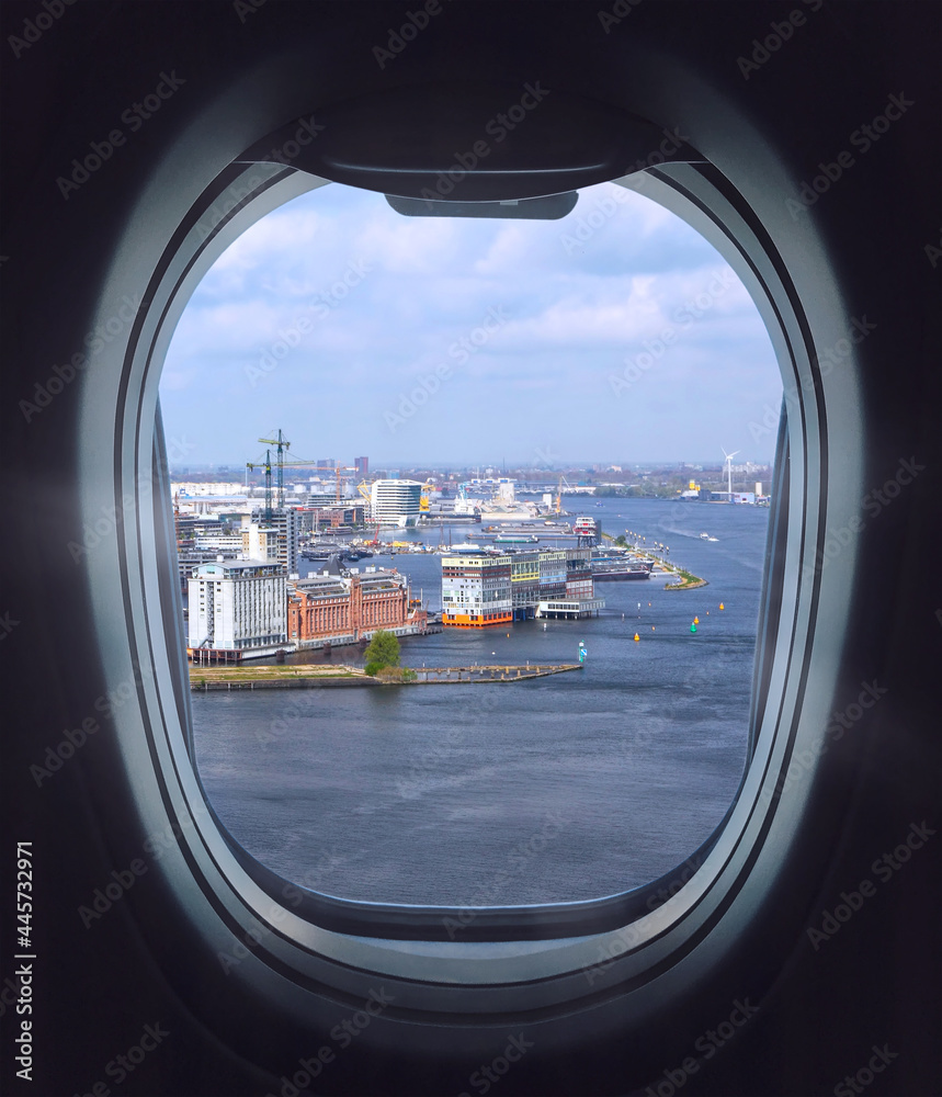 Looking through the airliner window out. Beautiful scenic Amsterdam ...