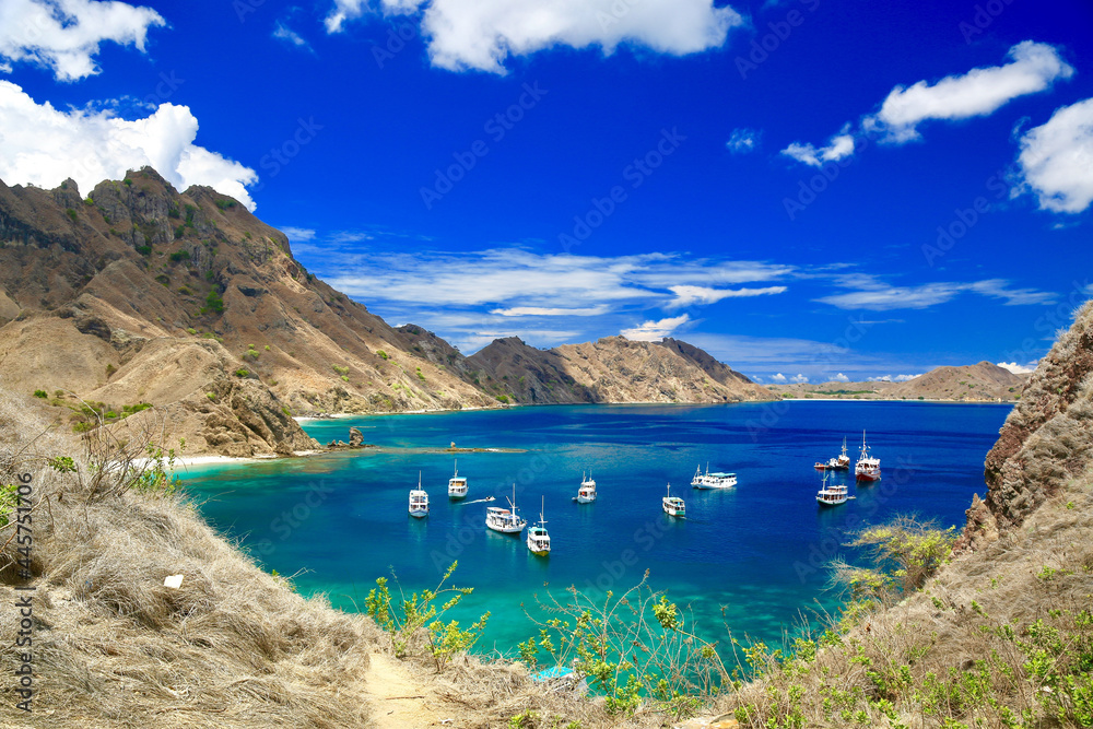 Landscape of sailing ships on the sea surrounded by rocky cliffs in ...