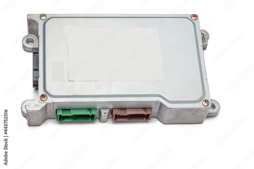 Metallic car engine control unit with plastic elements on a white ...