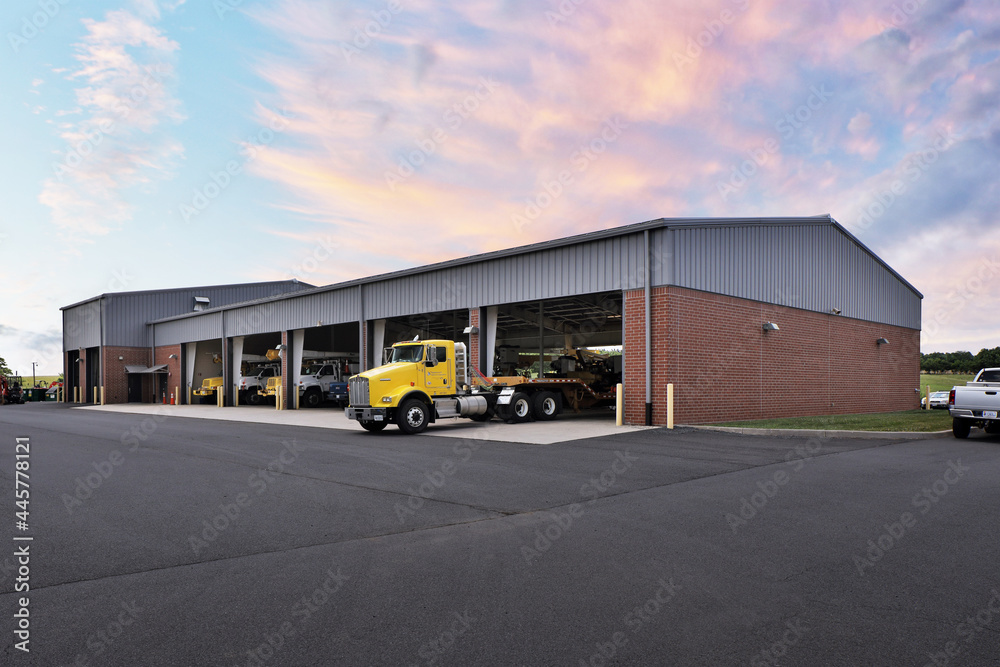 Brick garage parking building with yellow semi trucks Stock Photo ...