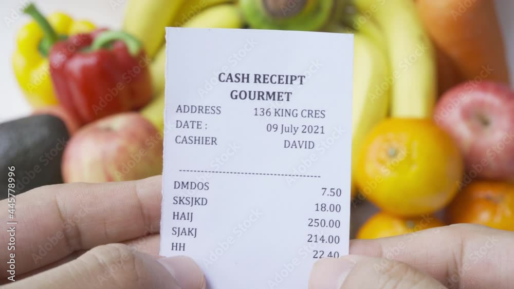 Vidéo Stock Hands hold shopping receipt bill with variety of colorful fresh fruits and ...