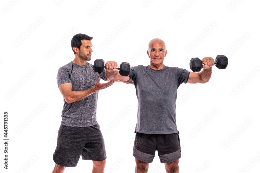 Old man with a personal trainer is conducting a fitness workout. On an ...