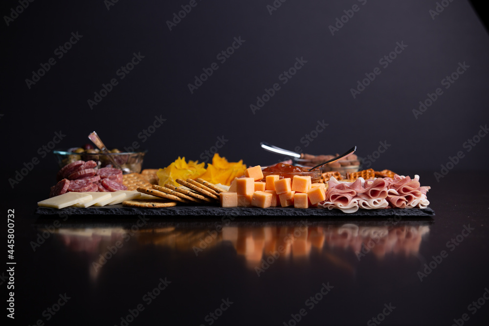 Full platter with meats, cheese, nuts, crackers, olives and an apricot ...