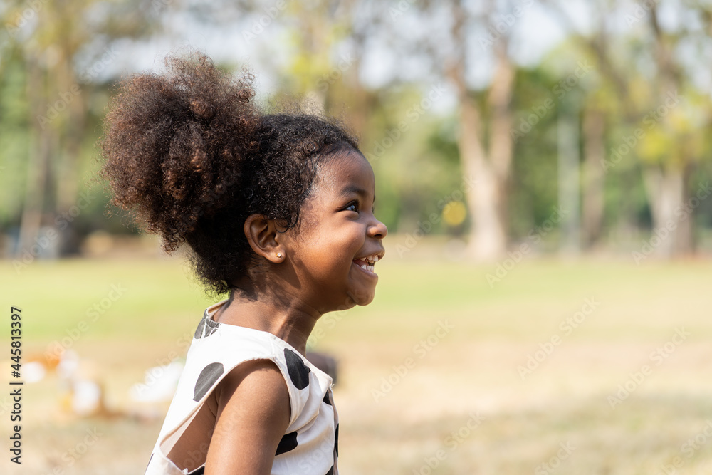 Cheerful African American toddler little girl playing outdoor in the ...