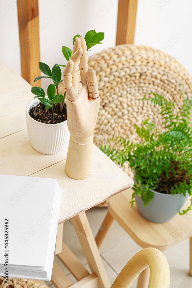 Wooden hand on table in room Stock Photo | Adobe Stock