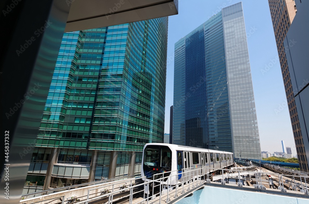 A metro train of Yurikamome Line making its way on the elevated rail ...