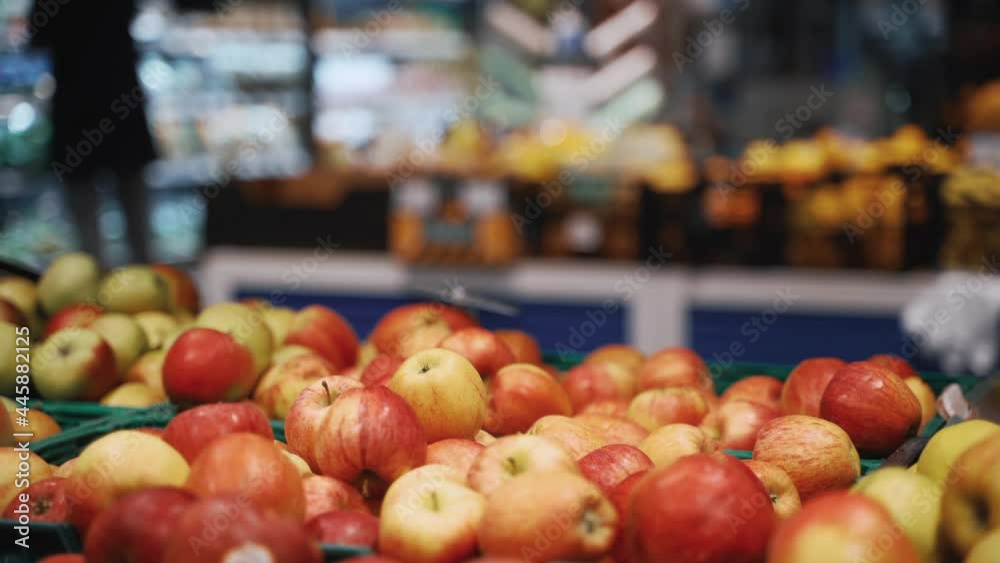 Red apples on shelf in supermarket. Grocery store, fruit section. Focus ...
