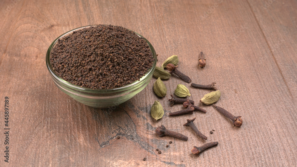 Black Tea Powder or dry dust tea powder, chai patti isolated in wooden ...