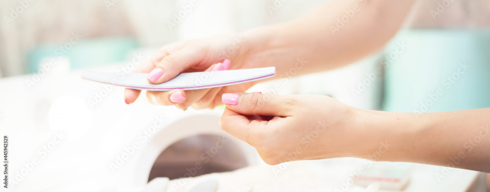 Removing old shellac gel polish with a nail file. Home manicure with a ...