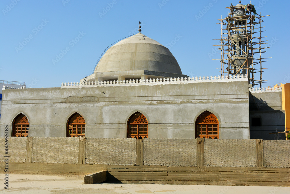 A new mosque under construction against the sunny blue sky with the ...