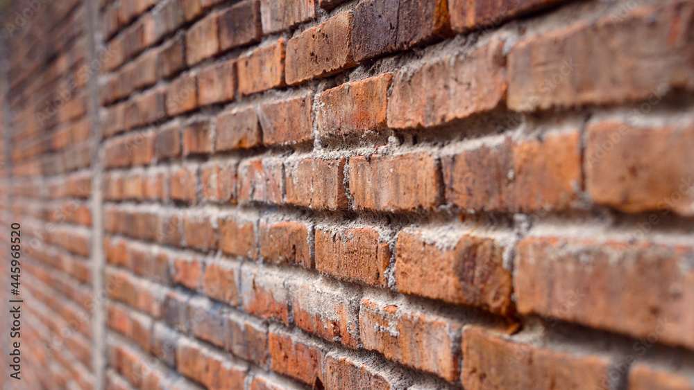 Red brick wall from the side, focus selected, blur on the far side ...