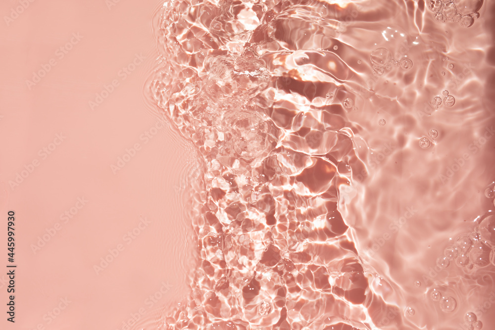 Pink liquid colored clear water surface texture with splashes bubbles ...