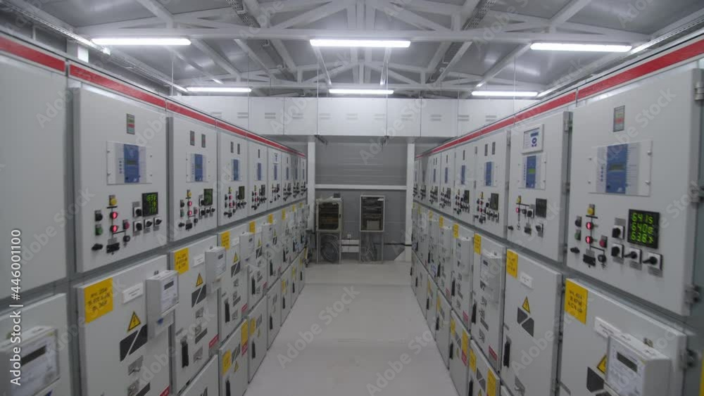 Motion between rows of light grey metal cabinets with switchgear in ...