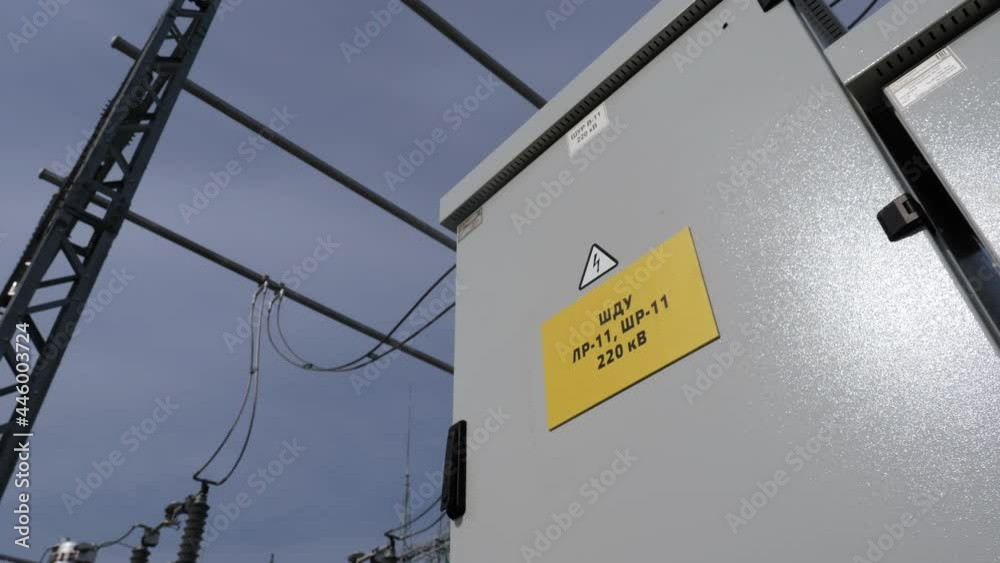 Facility power panel with yellow sign installed at electricity ...