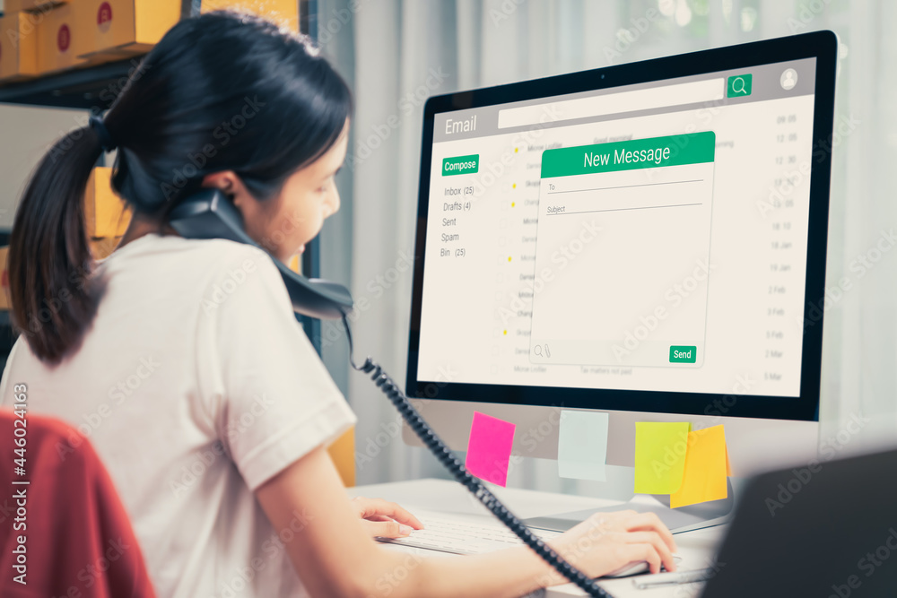 Woman using computer on table with new email message on laptop ...