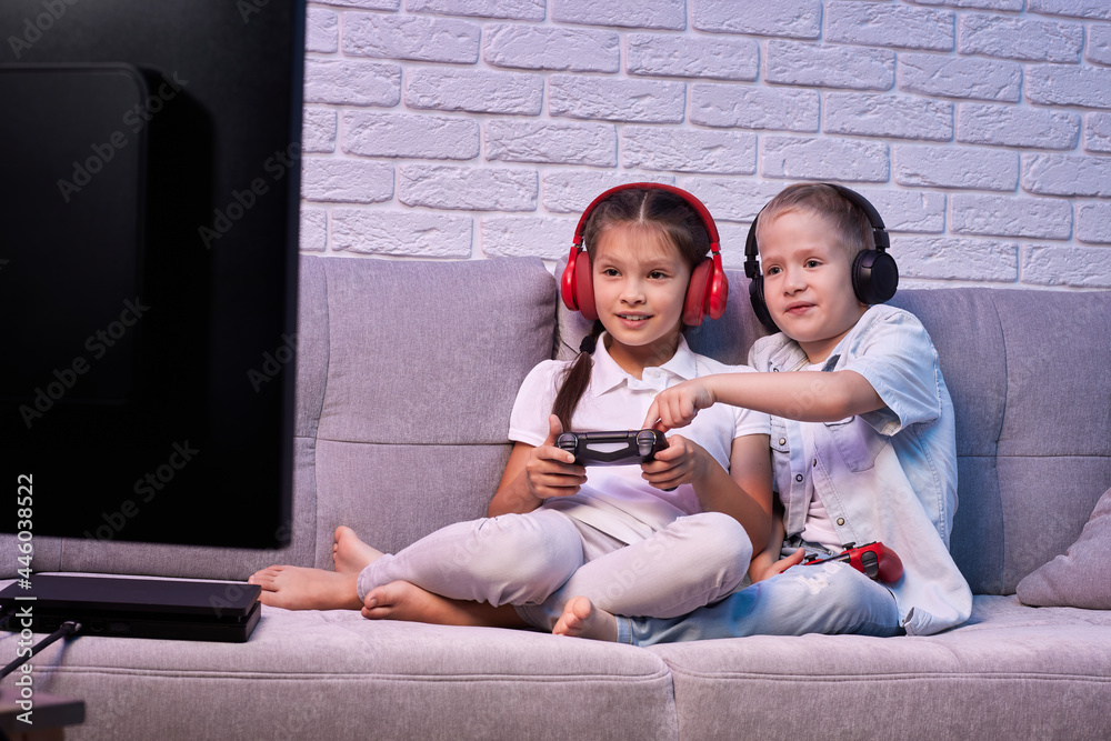 children playing video game with game console Stock Photo | Adobe Stock