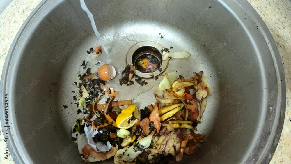 Food waste in the kitchen sink. Leftover food as recyclable waste ...
