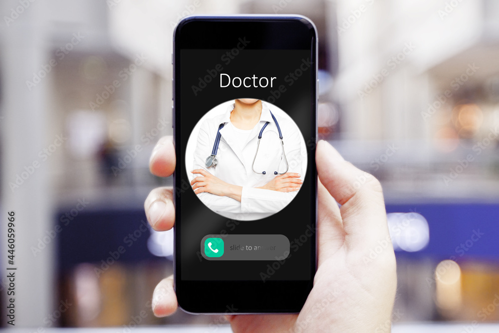 Hand holding cellphone with incoming call from doctor on blurry ...