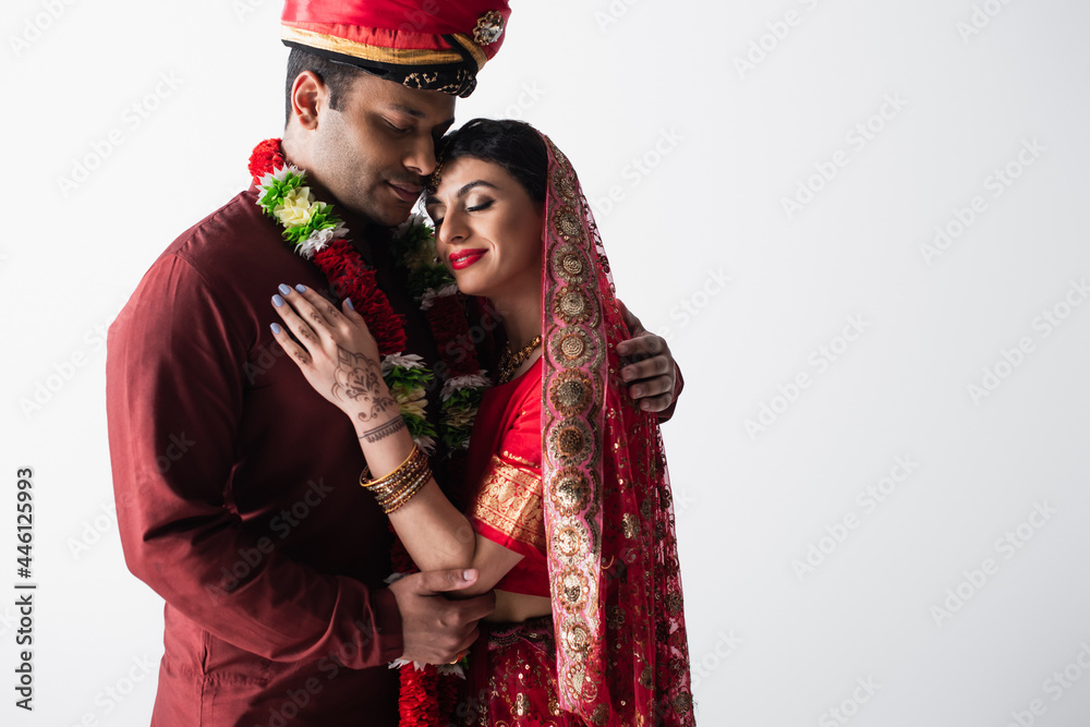 happy indian couple of husband and wife in traditional clothing hugging ...