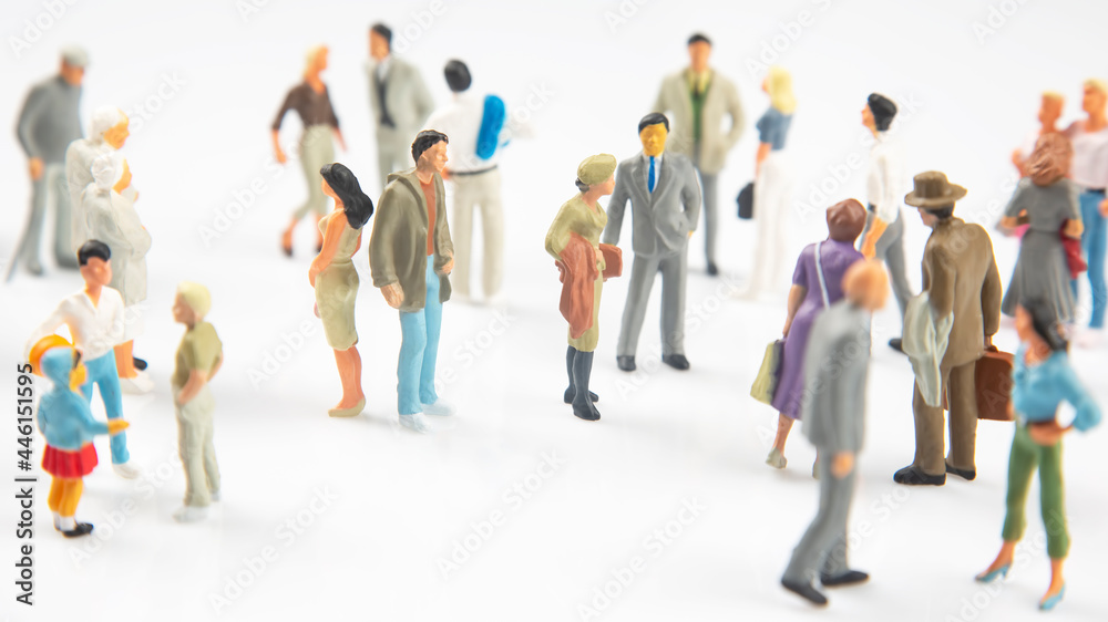 miniature people. different people stand on a white background ...