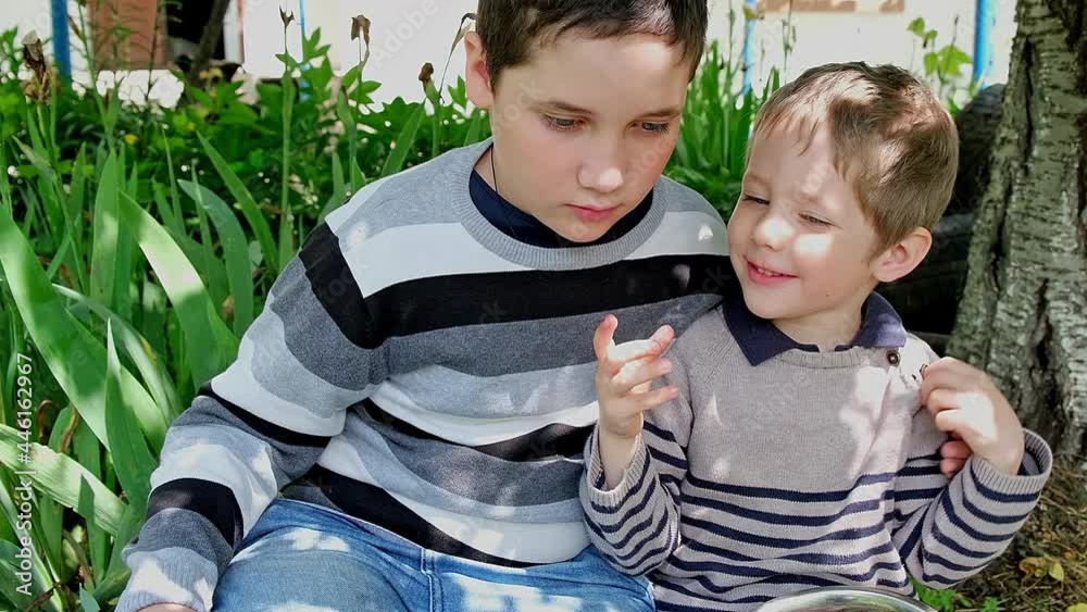 Funny boy hugging and kissing happy brother. Good family relations. A ...